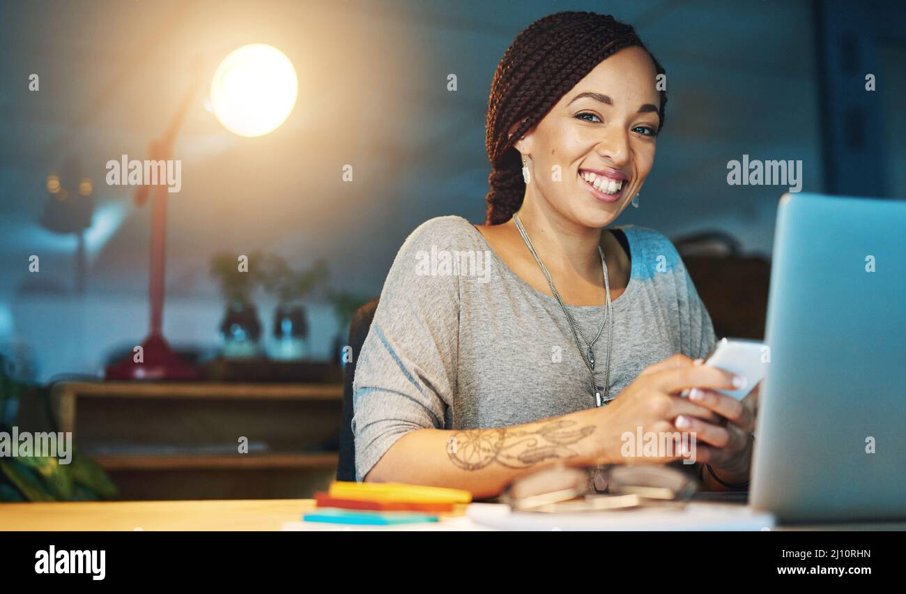 Im right on track. Cropped portrait of a young woman sending an sms ...