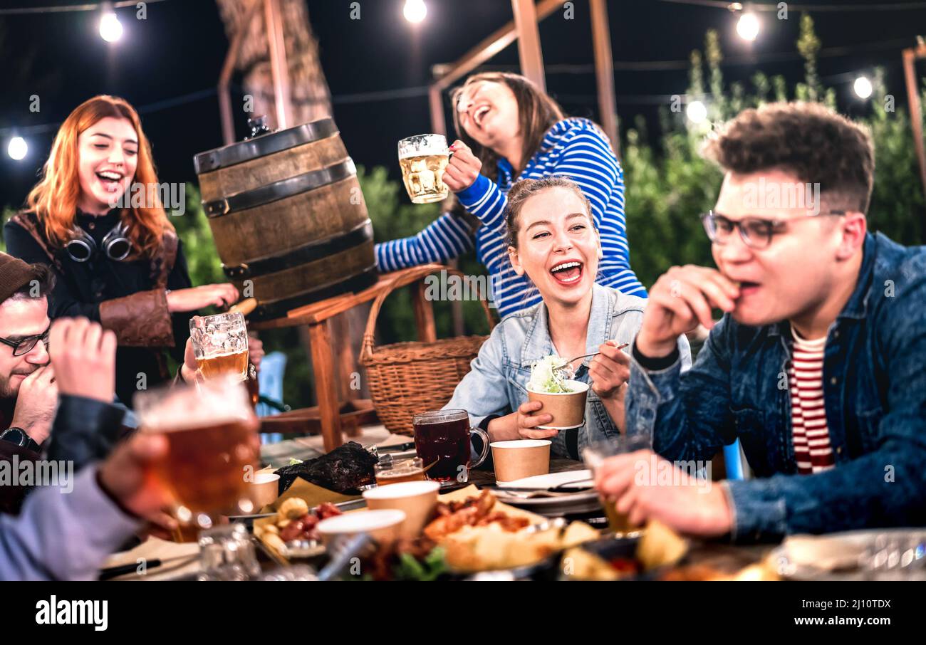 Happy cool friends having fun drinking out at beer garden feast ...