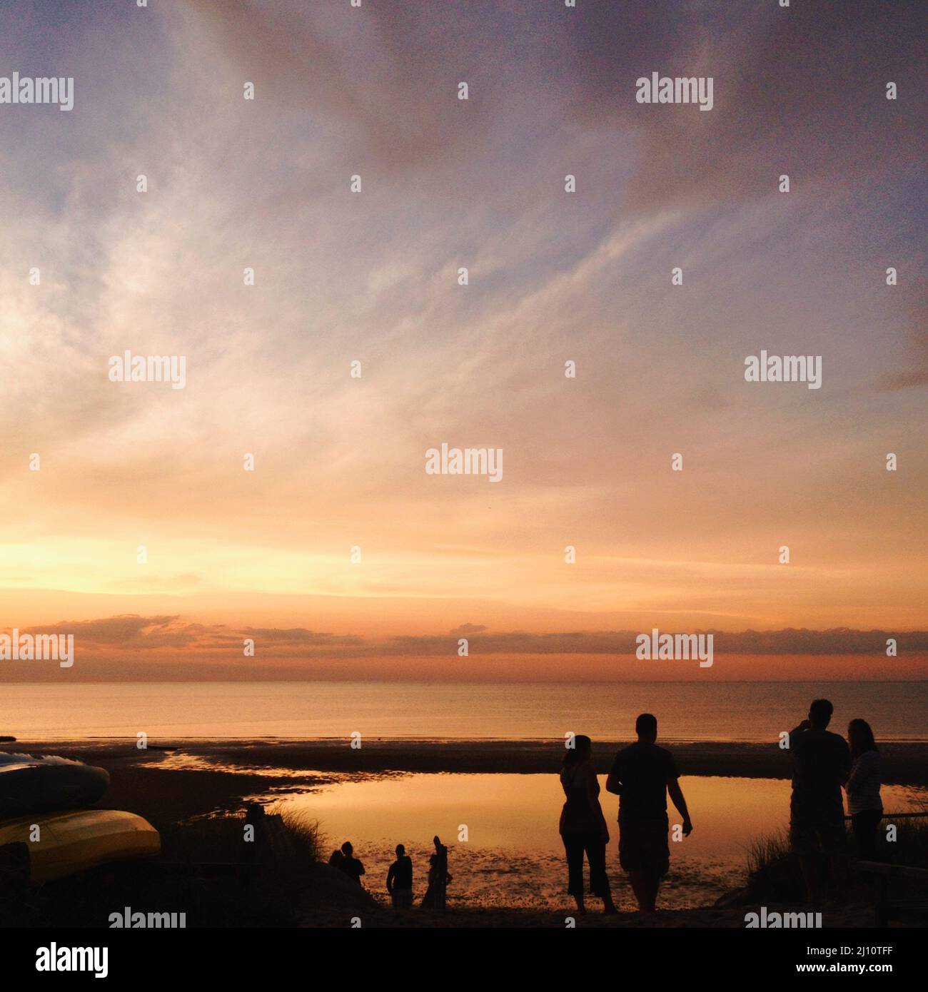 Silhouette of people watching the sunset over Cape Cod Bay Stock Photo ...