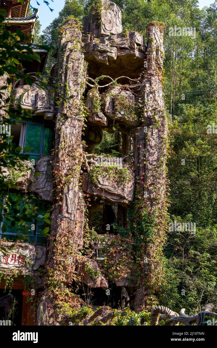 Creepers-covered building made of rockery stone in an outdoor park ...