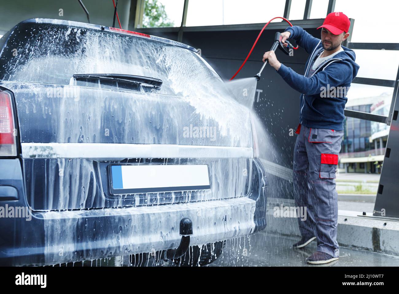 Car wash worker is washing client's car Stock Photo - Alamy