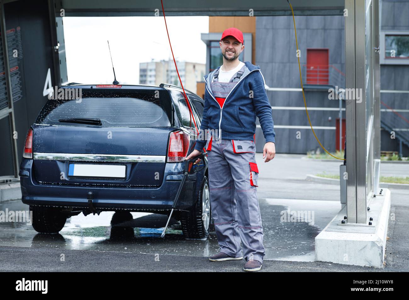 Car wash worker is washing client's car Stock Photo - Alamy