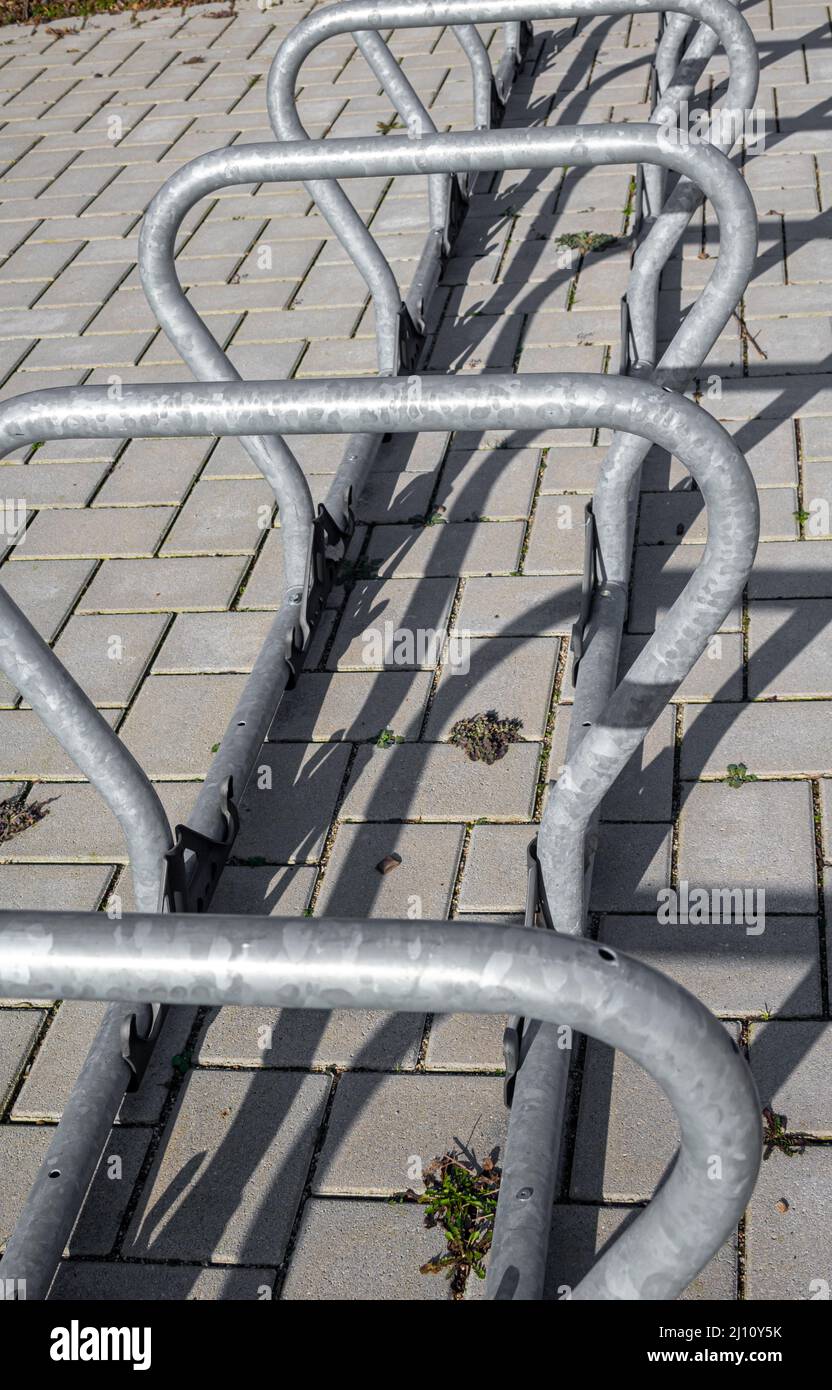 Close ups of a group of modern bike racks in bracket shape on a large ...