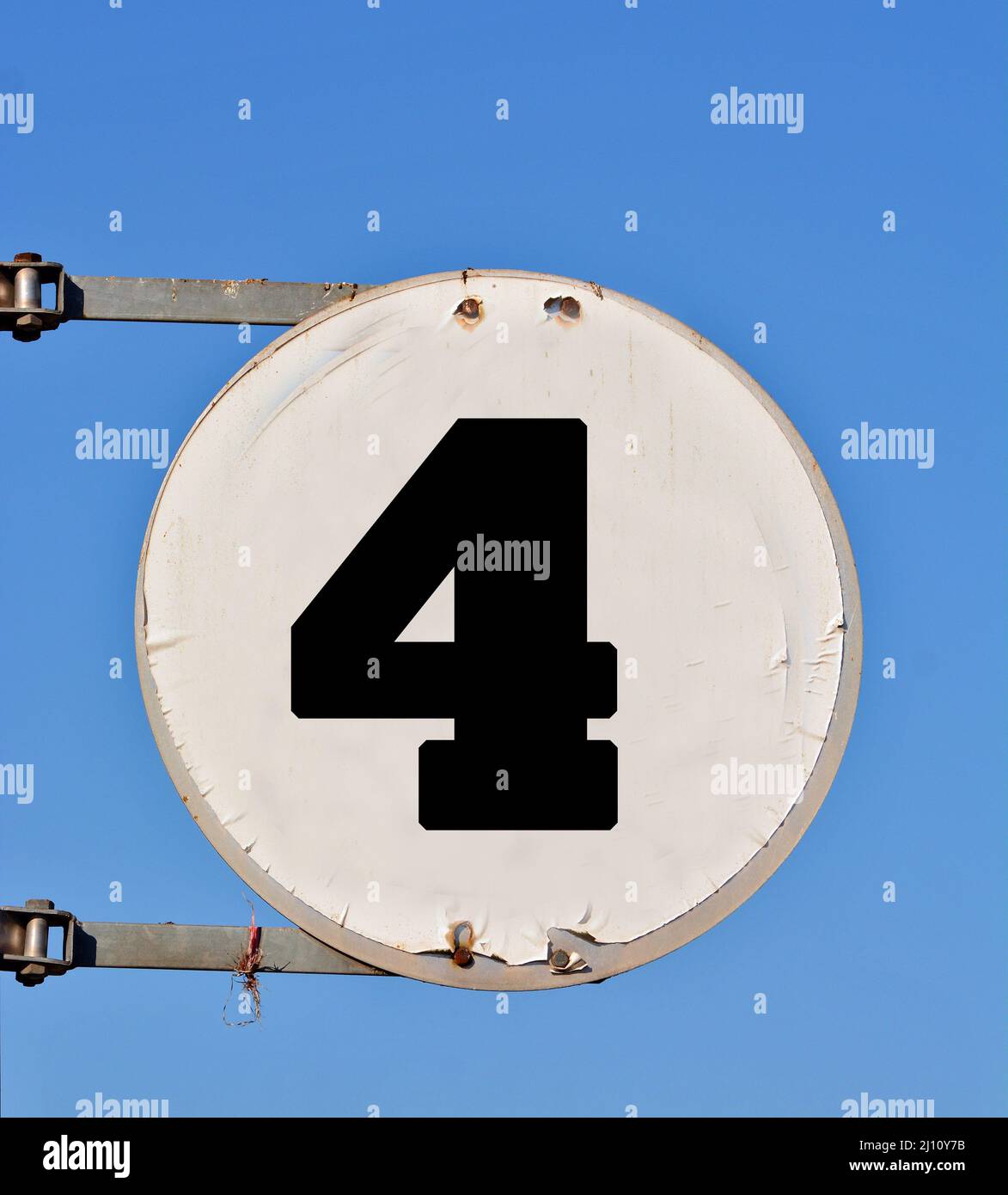 Round-shaped street banner with the number 4 on it in the background of ...