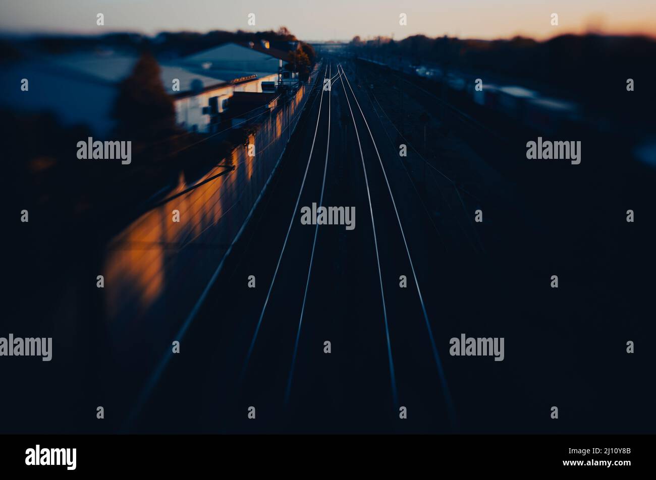 View from a train in motion to the railway next to residential ...