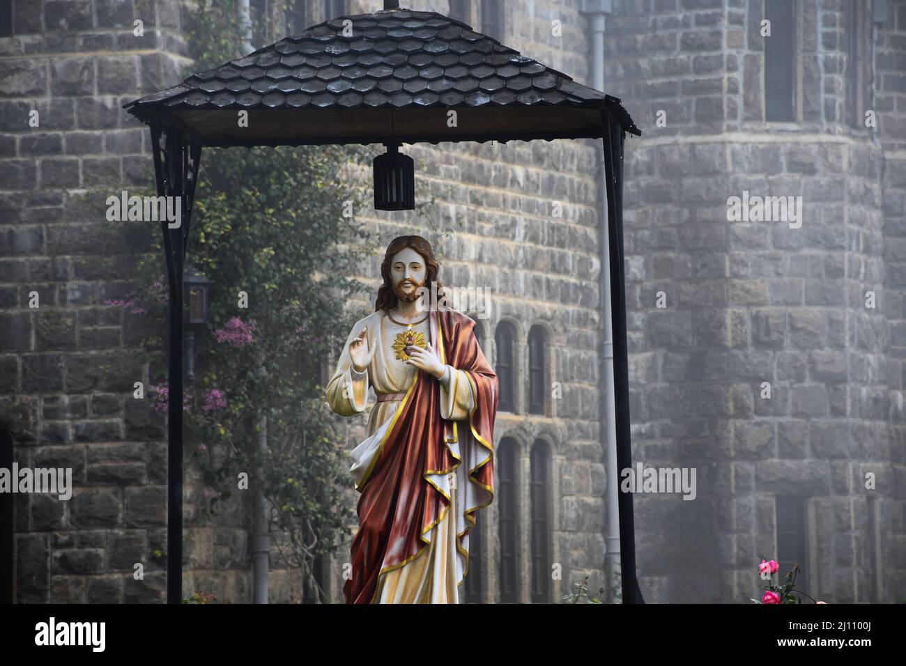 Jesus Christ statue with a cathedral building in the back Stock Photo ...