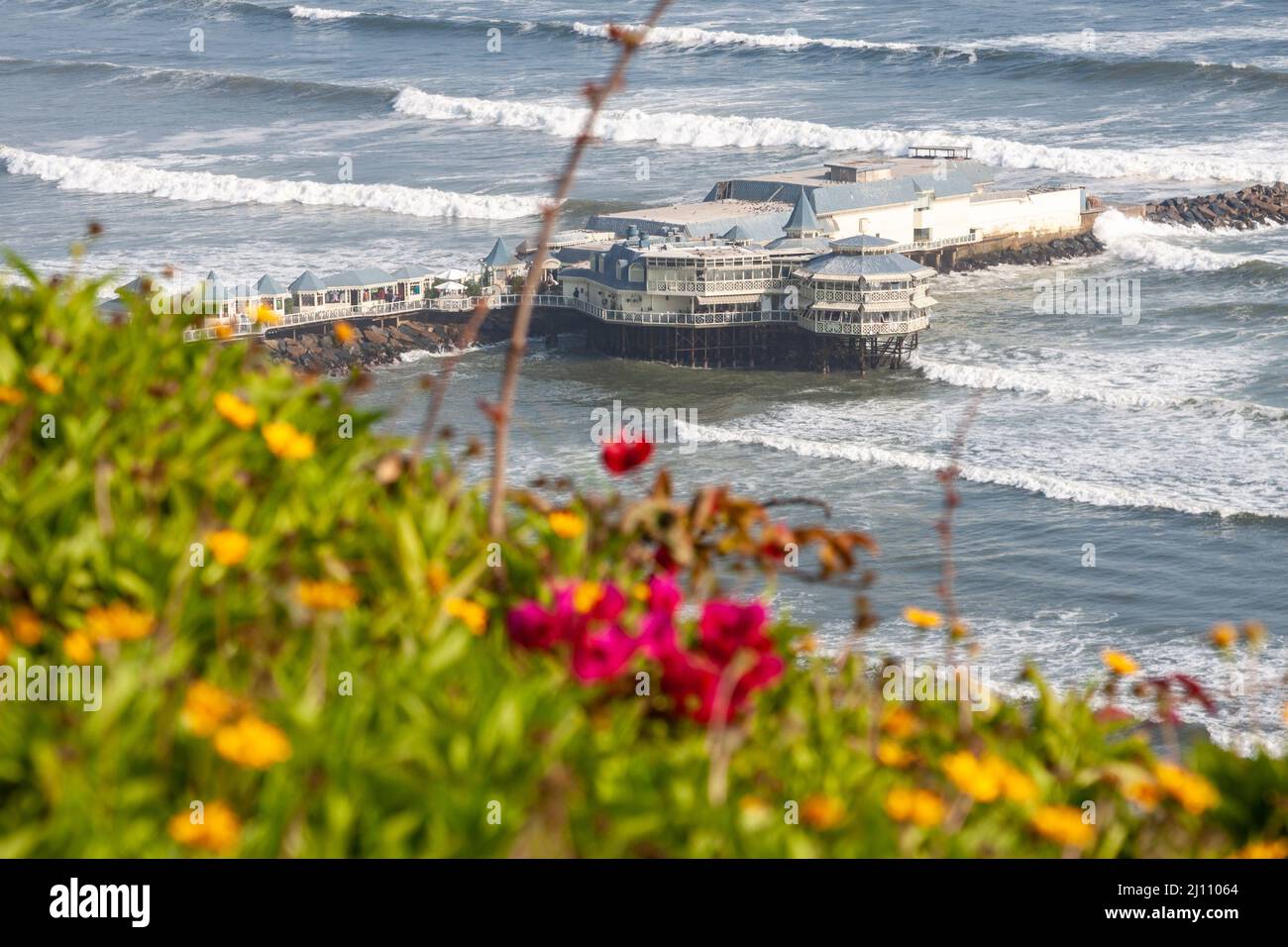 Aerial view of a pier on Miraflores beach in Lima, Peru behind out of ...