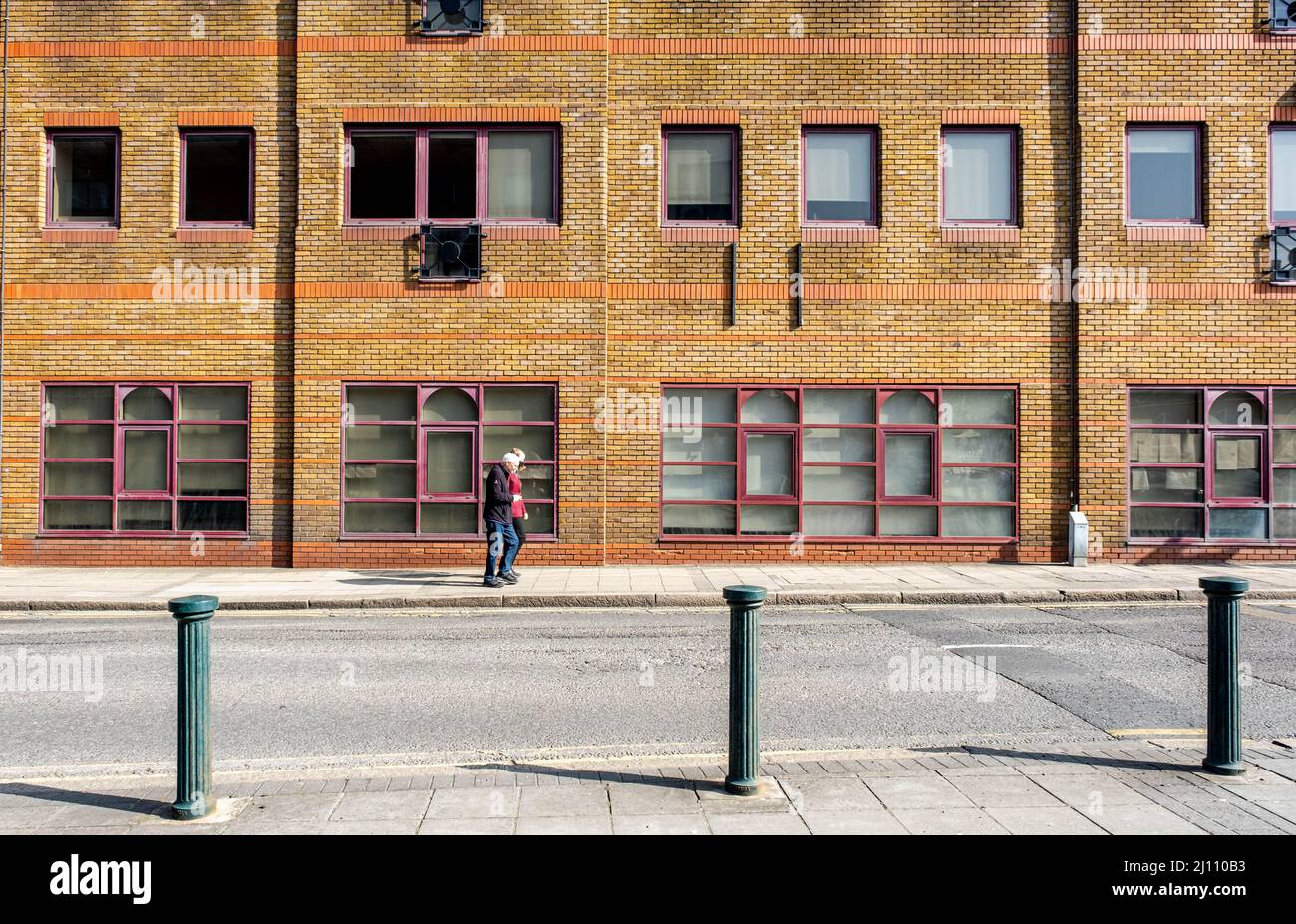 Man walking past building hi-res stock photography and images - Alamy