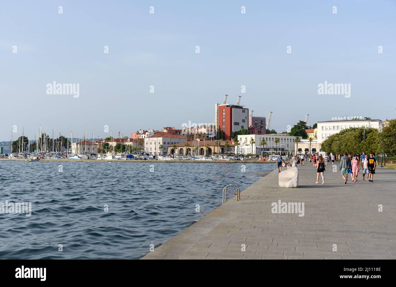 People walking on the waterfront promenade in city of Koper in Slovenia ...