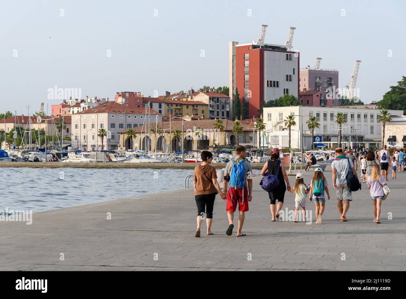 People walking on waterfront promenade in city of Koper in Slovenia ...