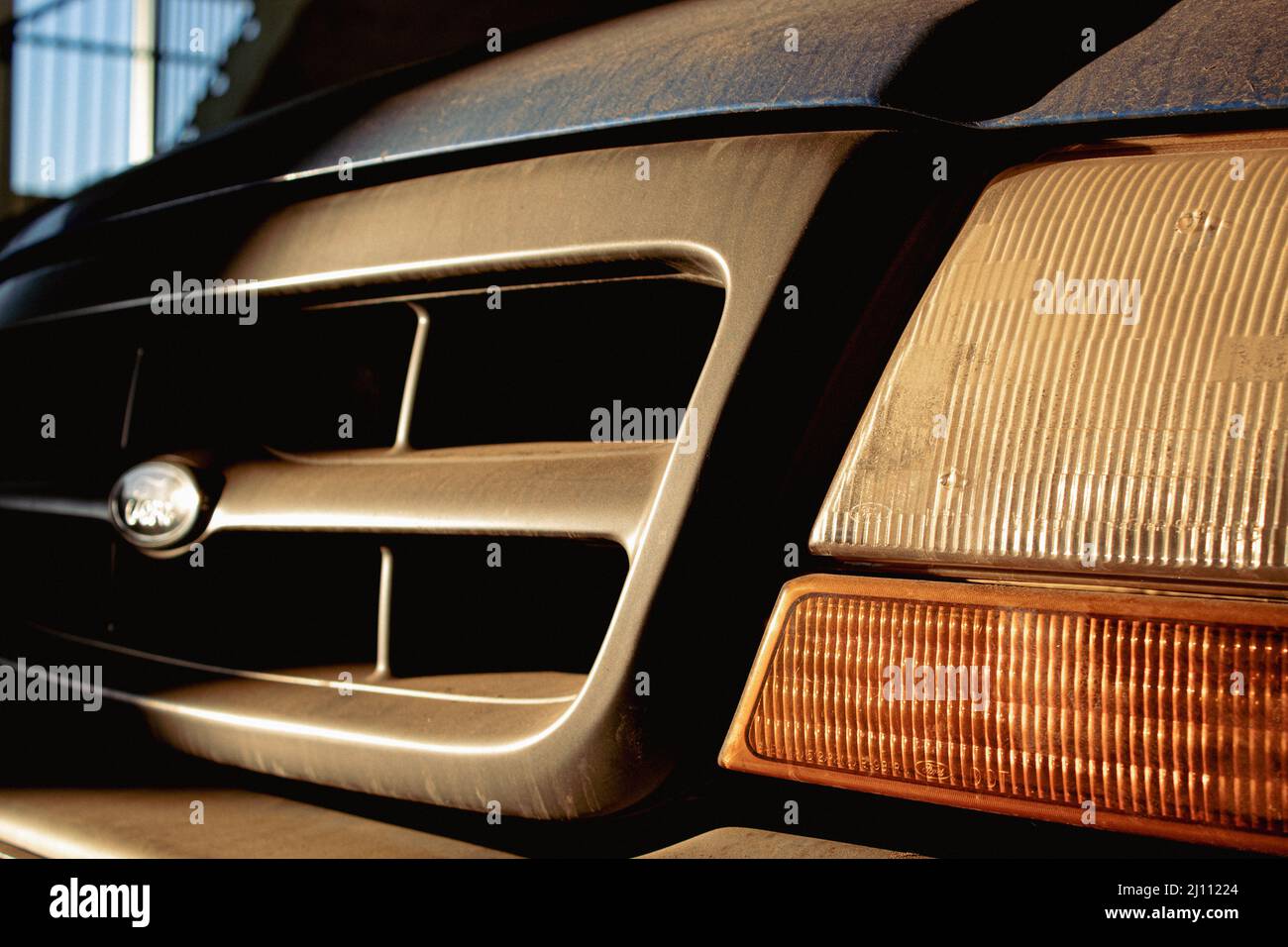 Front left headlight and radiator grille on a blue car Stock Photo - Alamy