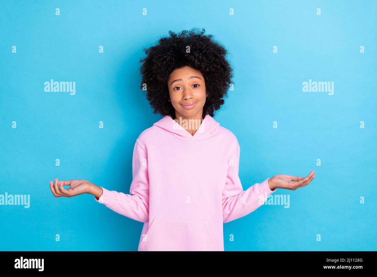 Portrait of attractive indifferent cheerful bushy haired girl shrugging ...