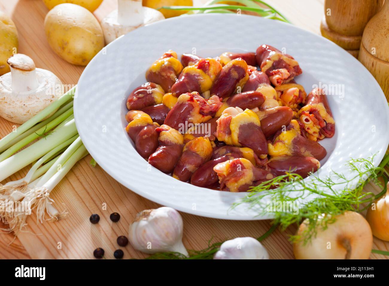 Raw chicken hearts with fresh vegetables Stock Photo - Alamy