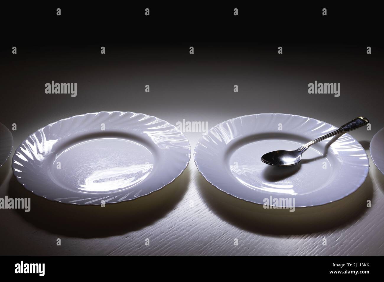 Group of soup plates and just one spoon Stock Photo - Alamy
