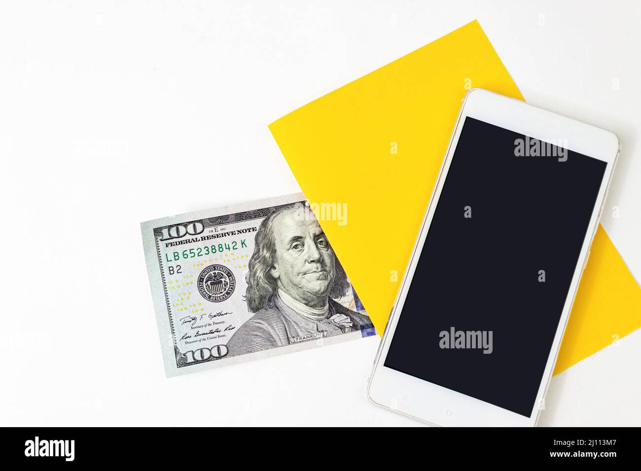Yellow a piece of paper, american dollar banknote and empty screen ...