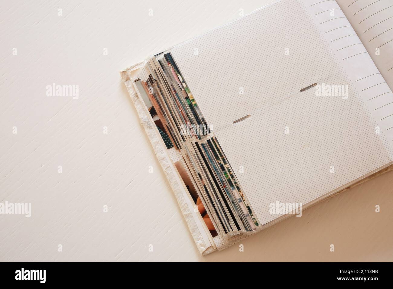 Photo album on white table, empty pages details Stock Photo - Alamy