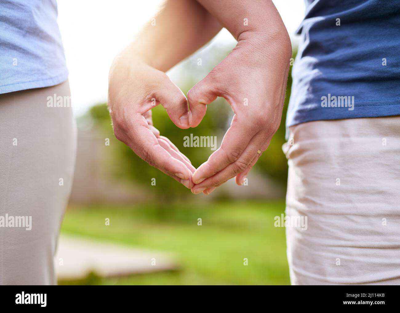 Together we form one strong heart. Closeup of two unrecognizable people ...