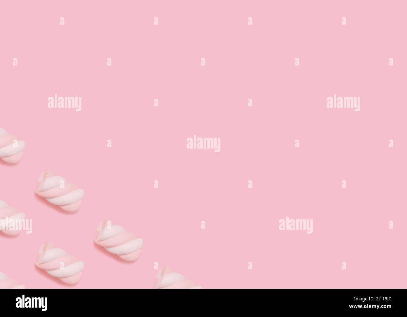 Swirl two-tone candies on pastel pink background Stock Photo - Alamy