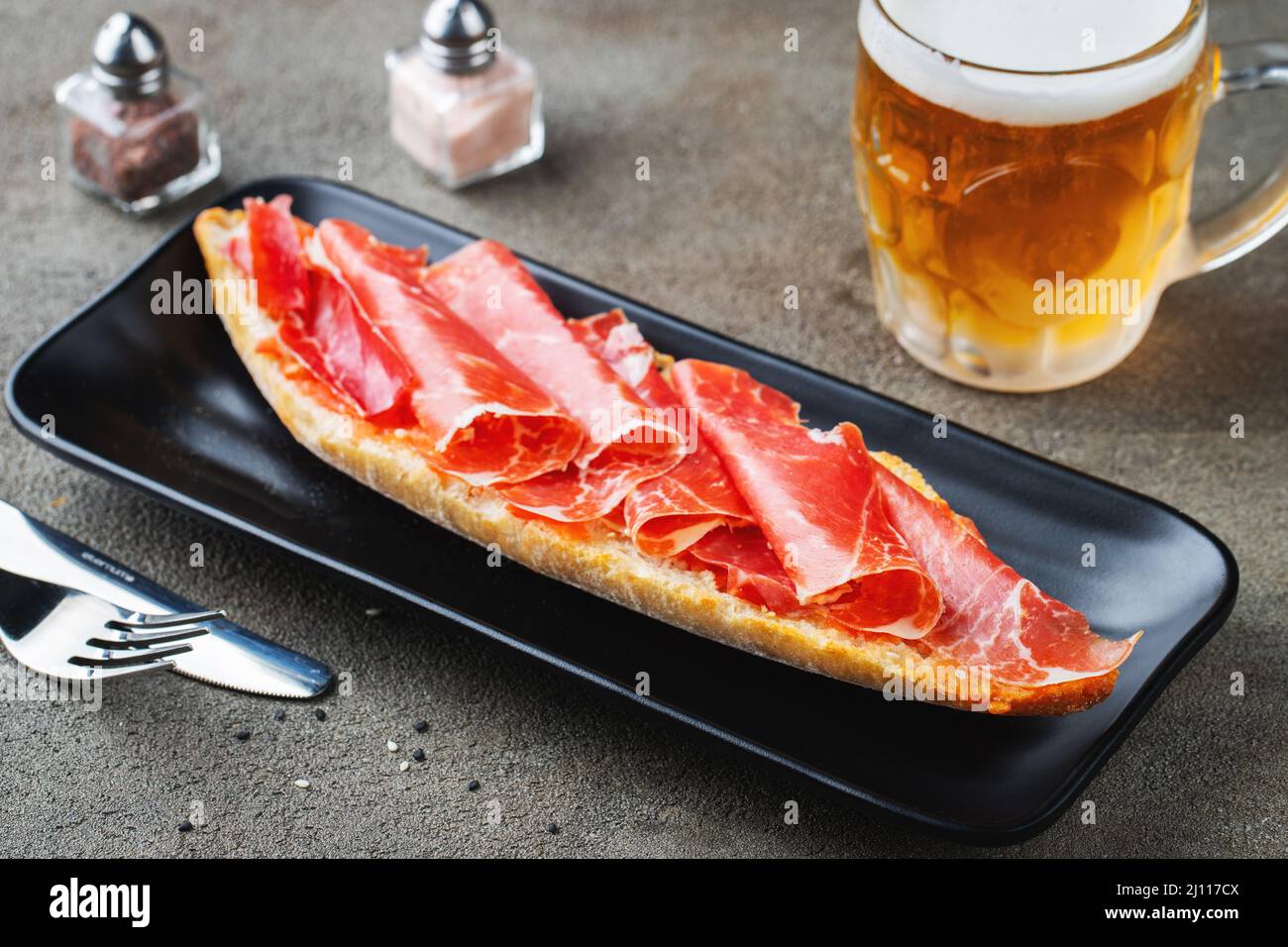 Traditional Spanish breakfast. Tostada with different toppings on a ...