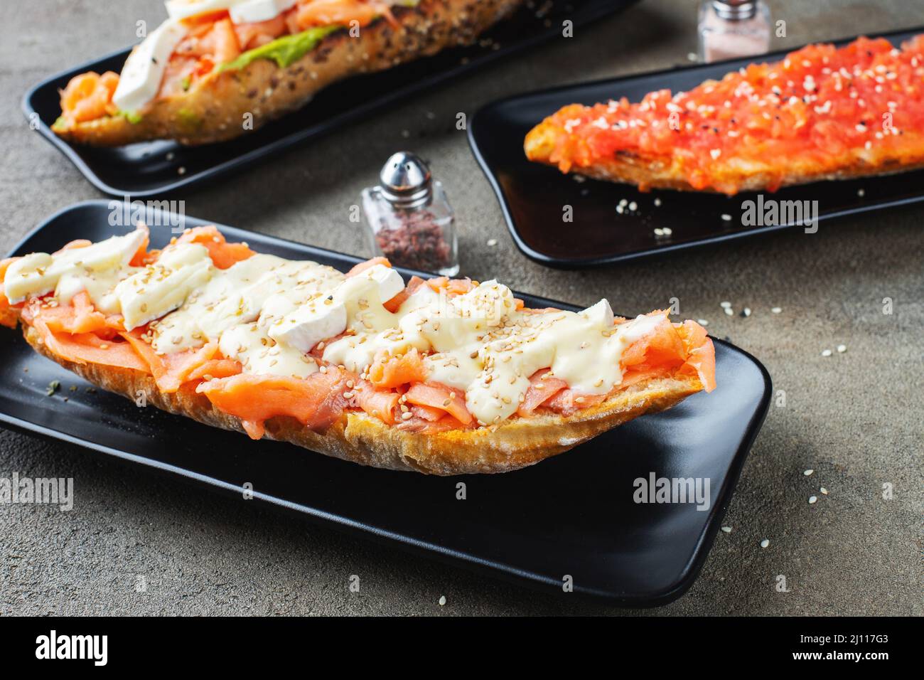 Traditional Spanish breakfast. Tostada with different toppings on a ...