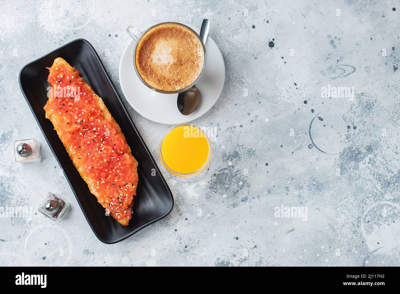 Traditional Spanish breakfast. Tostada with different toppings on a ...