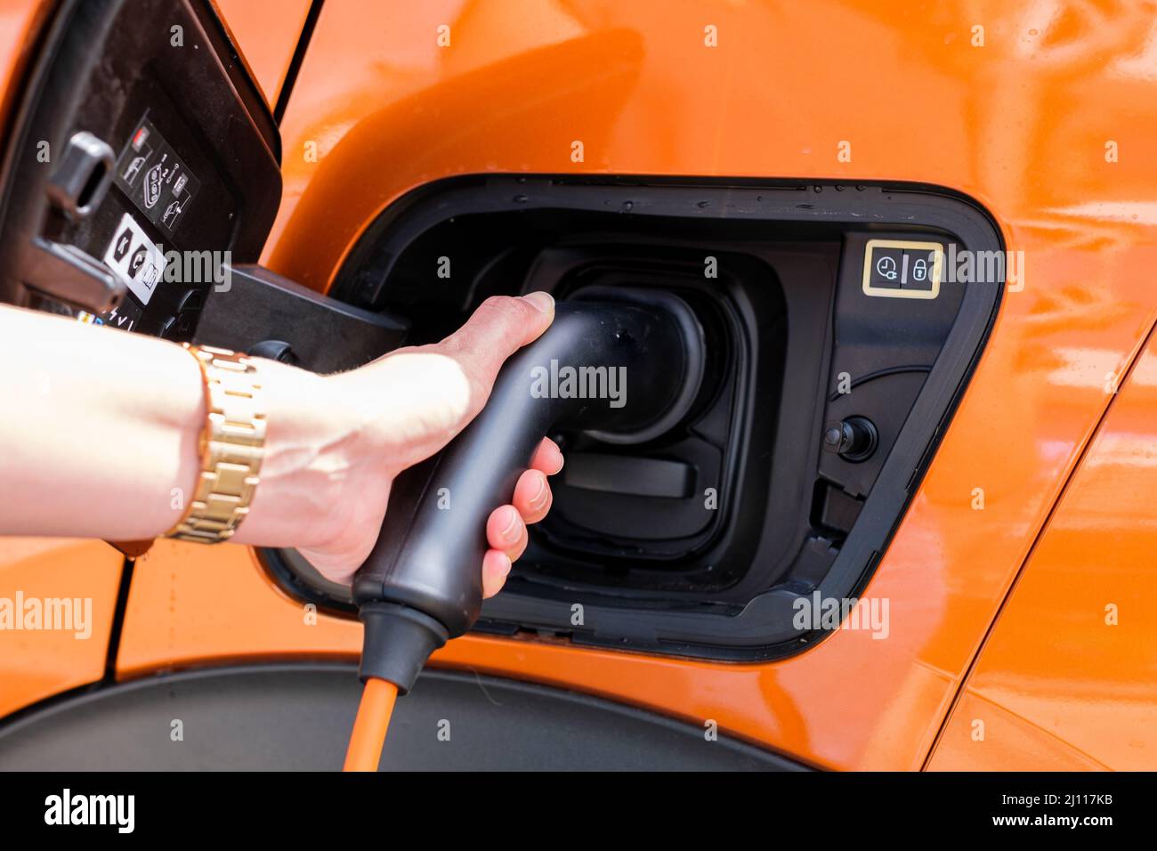 Woman connecting charging cable hi-res stock photography and images - Alamy