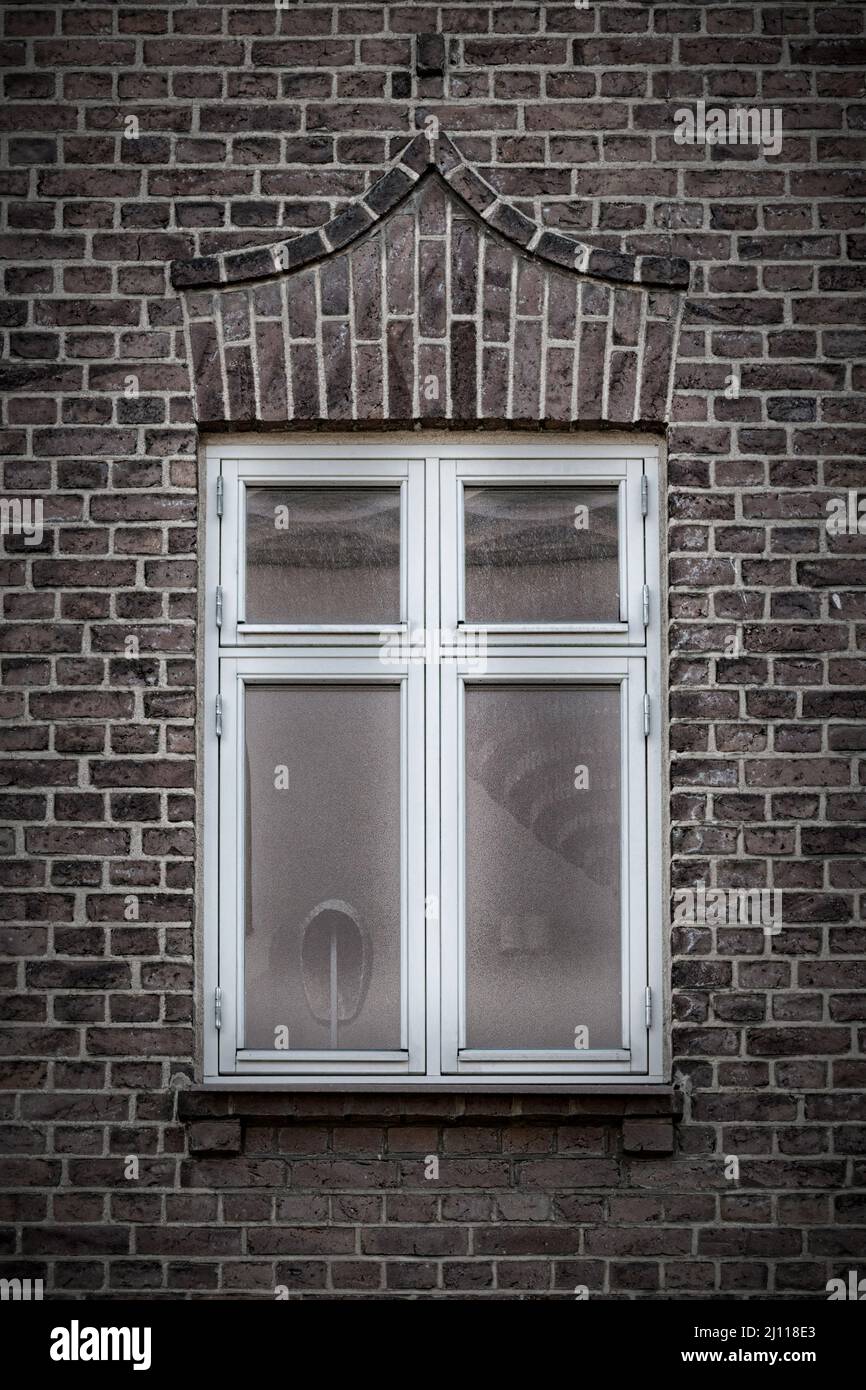 A brick wall of a building with one single window Stock Photo - Alamy