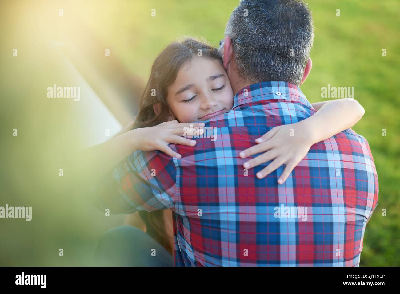 Daddys little darling. Shot of a happy little girl hugging her father ...
