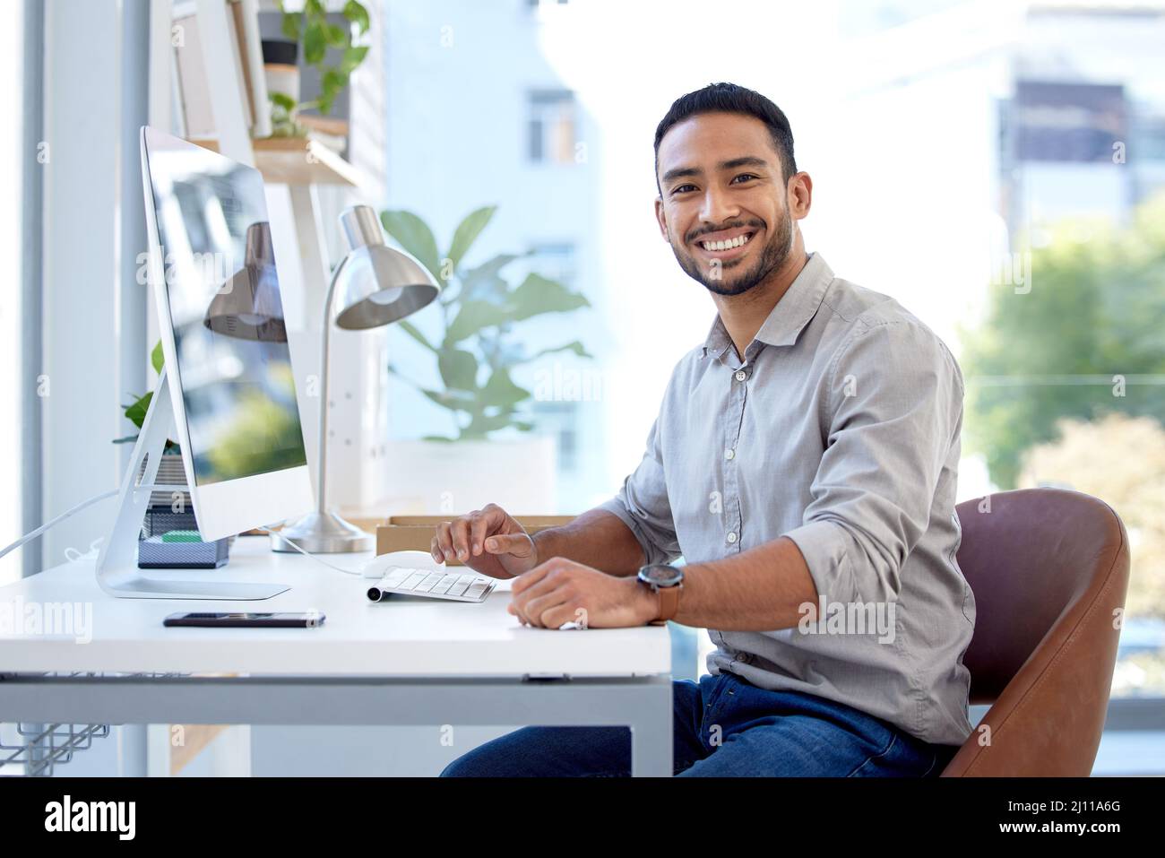 Ambition never comes to an end. Portrait of a young businessman working ...