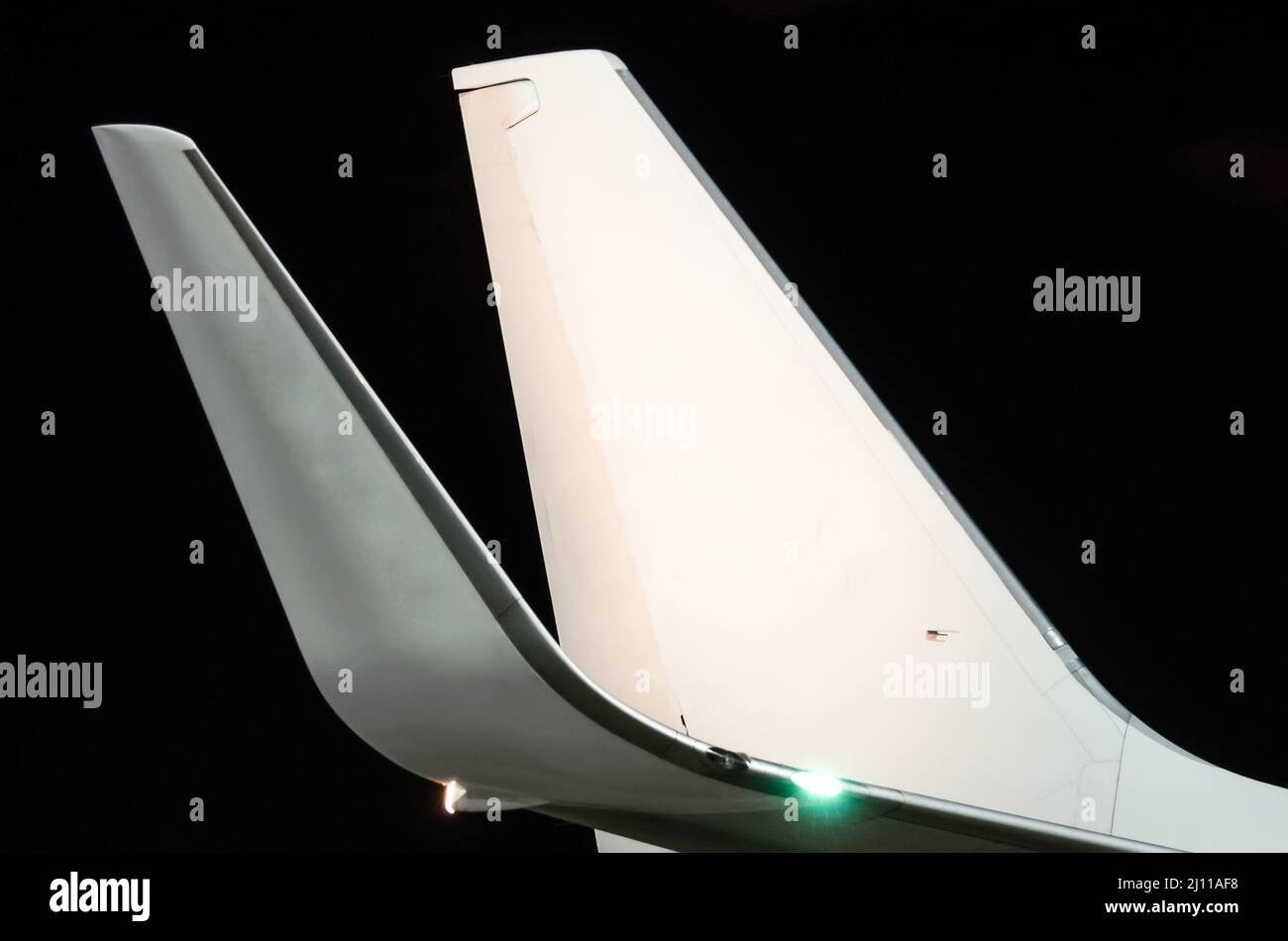 Wings and tail with night lights at the airport Stock Photo - Alamy