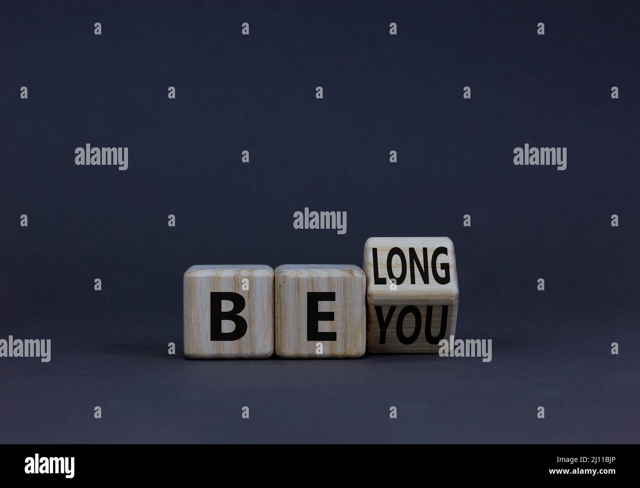 Be you, belong symbol. Turned a wooden cube and changed concept words ...