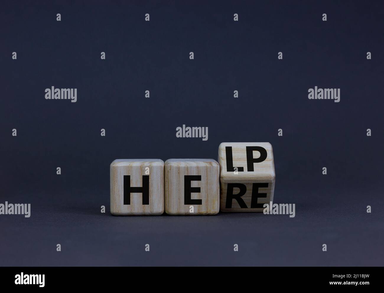 Help is here support symbol. Turned a wooden cube with concept word ...
