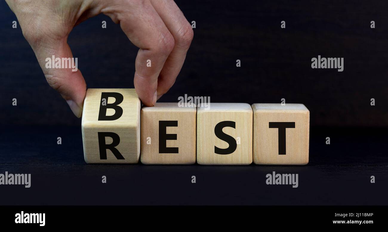 Best rest symbol. Businessman turns wooden cubes and changes the word ...