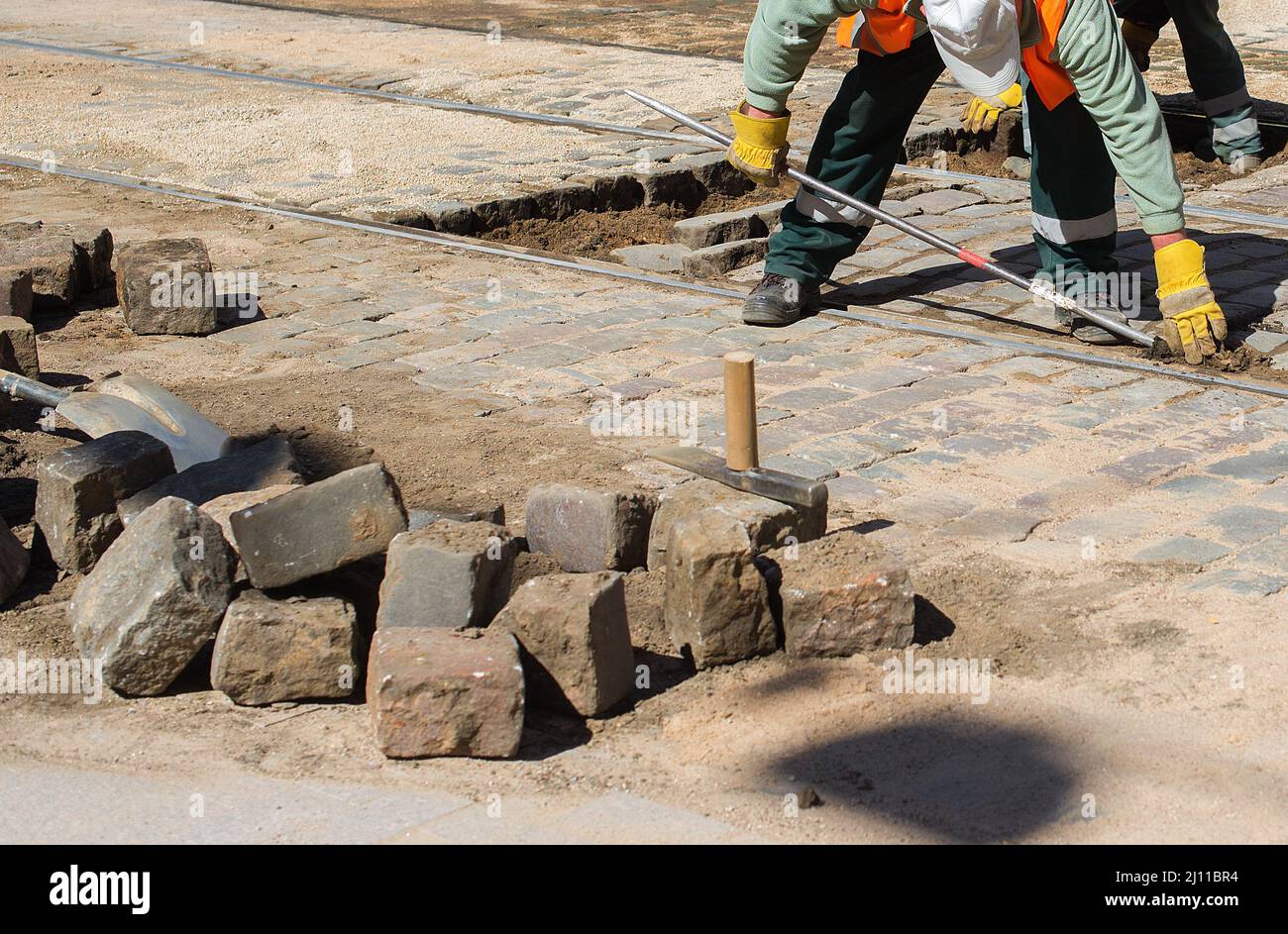 Photo of workers paving stones Stock Photo - Alamy