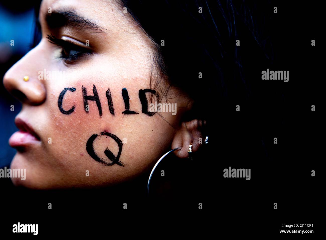 A woman with Child Q written on her face during the rally ...