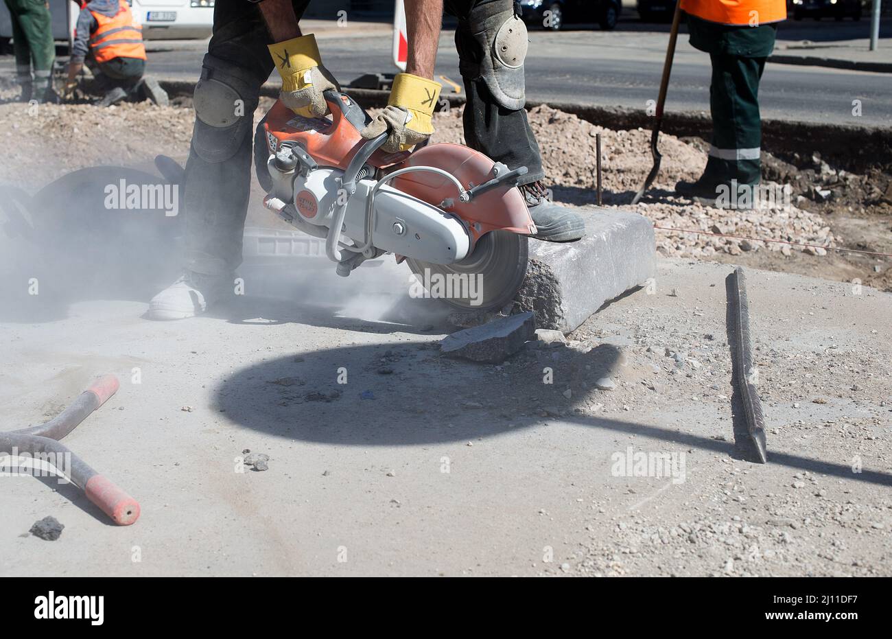 Photo of workers and a pavement under repair Stock Photo - Alamy