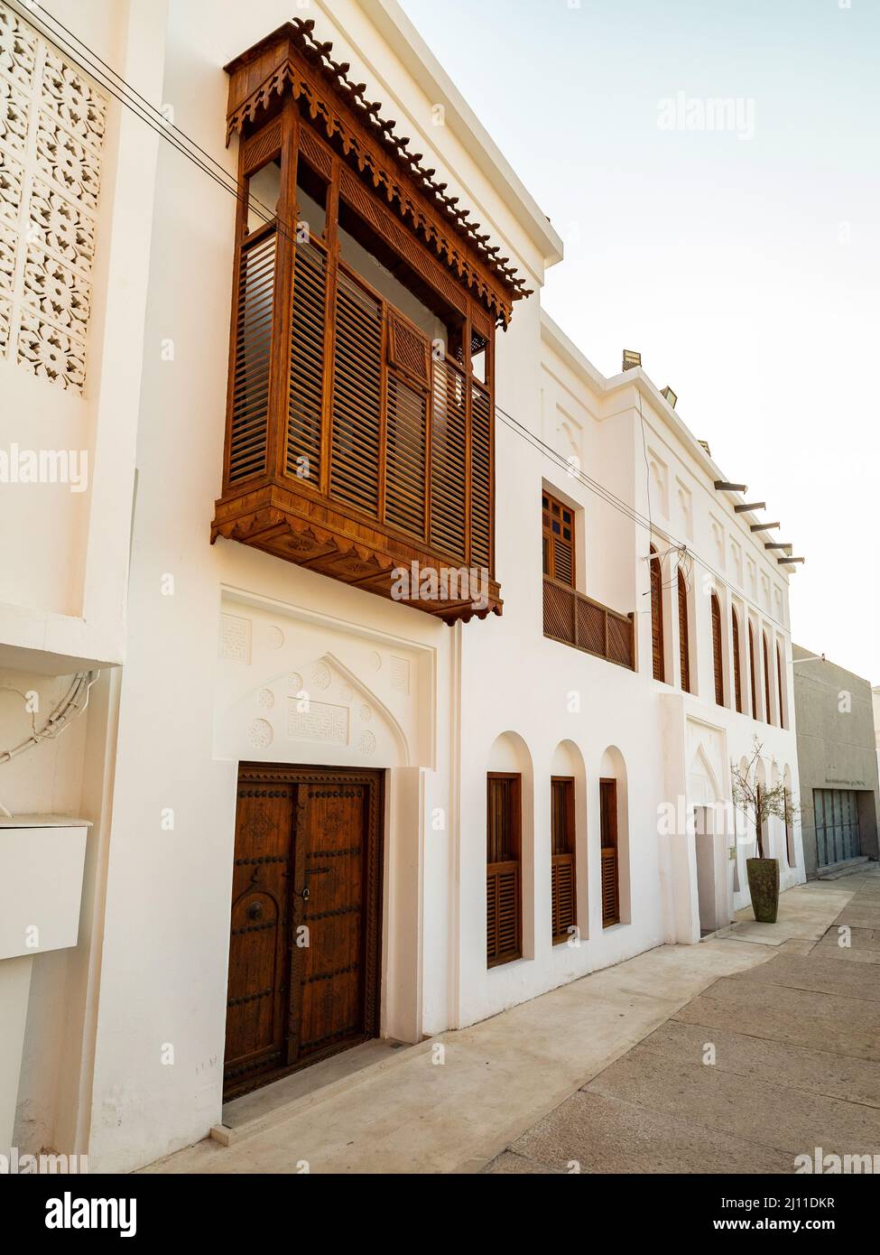 Vertical shot of white-walled buildings with wooden mashrabiya ...