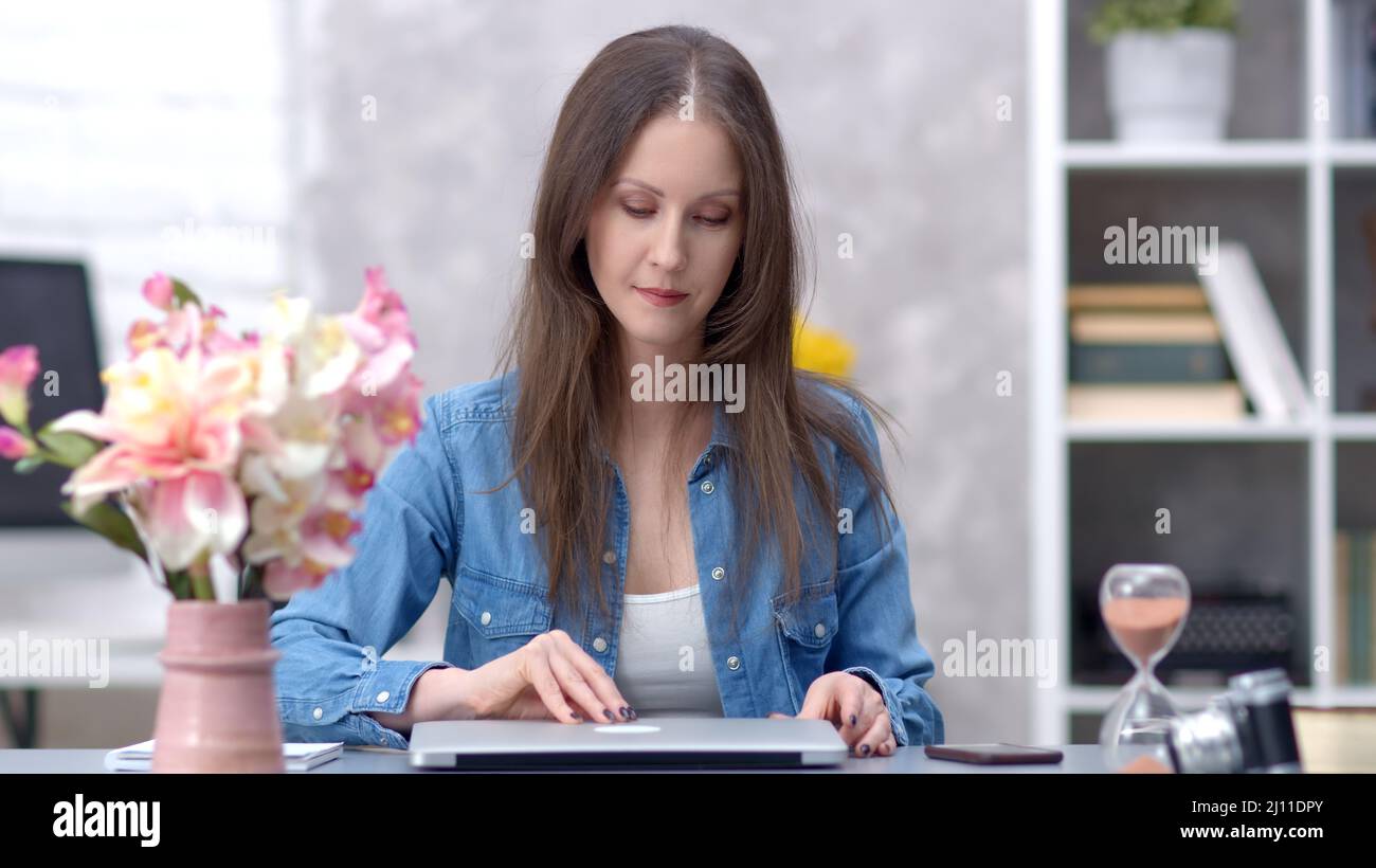 Woman opening laptop starting typing hi-res stock photography and ...