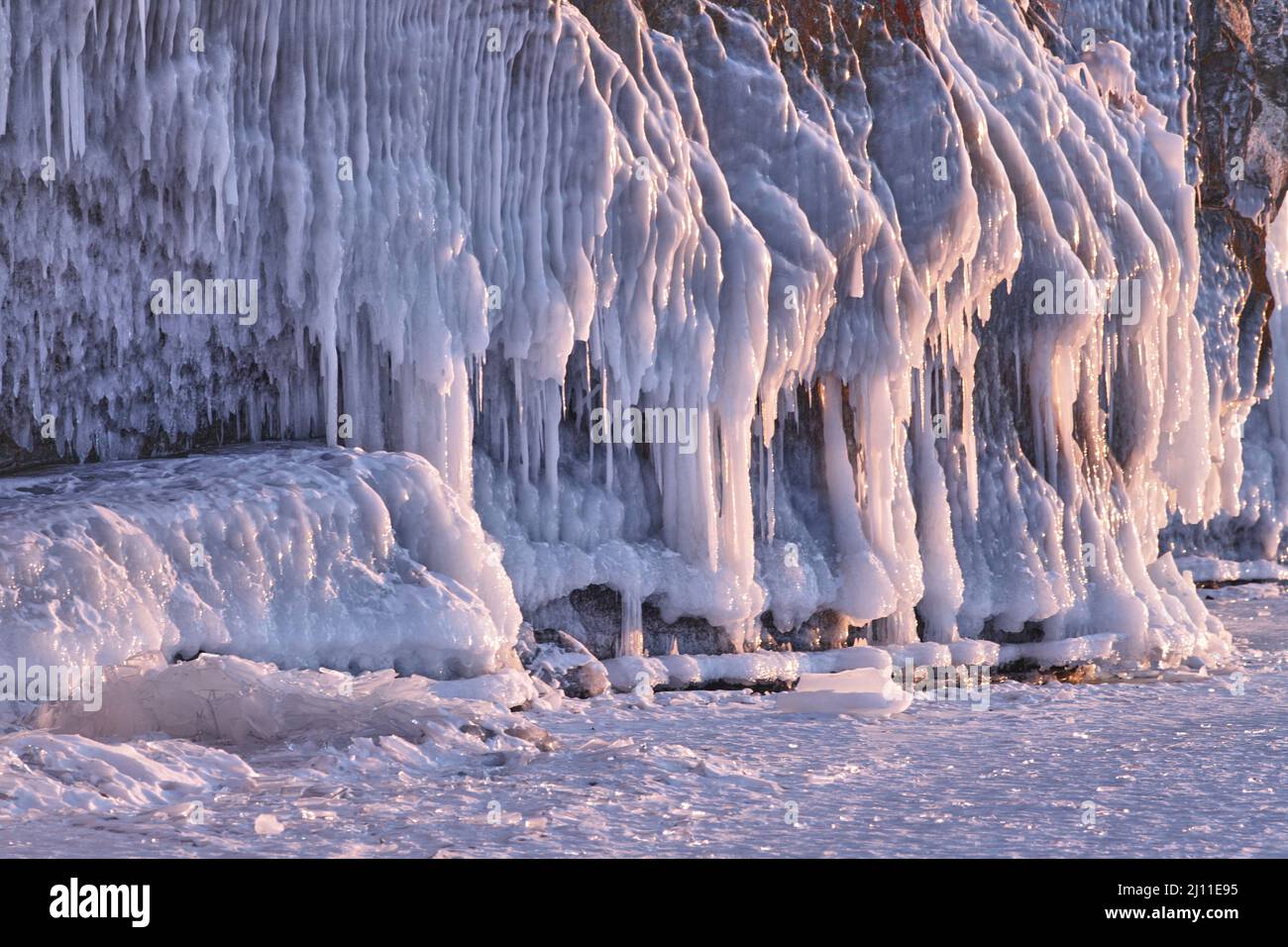 Beautiful winter background with frozen water jets in sunset light ...