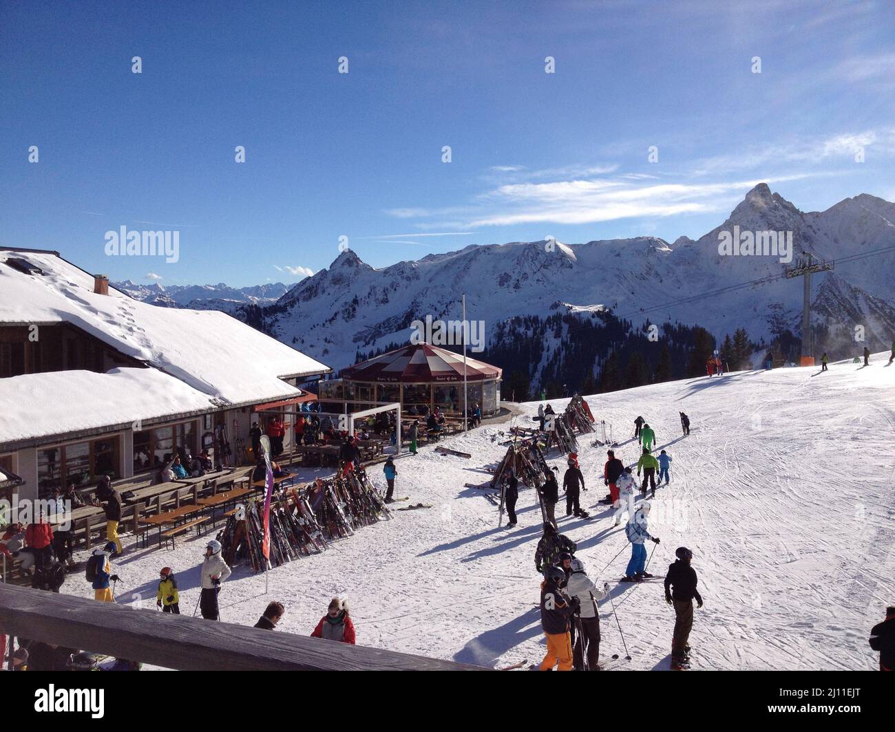 Shot of tourists doing ski on the snow with mountains view Stock Photo ...