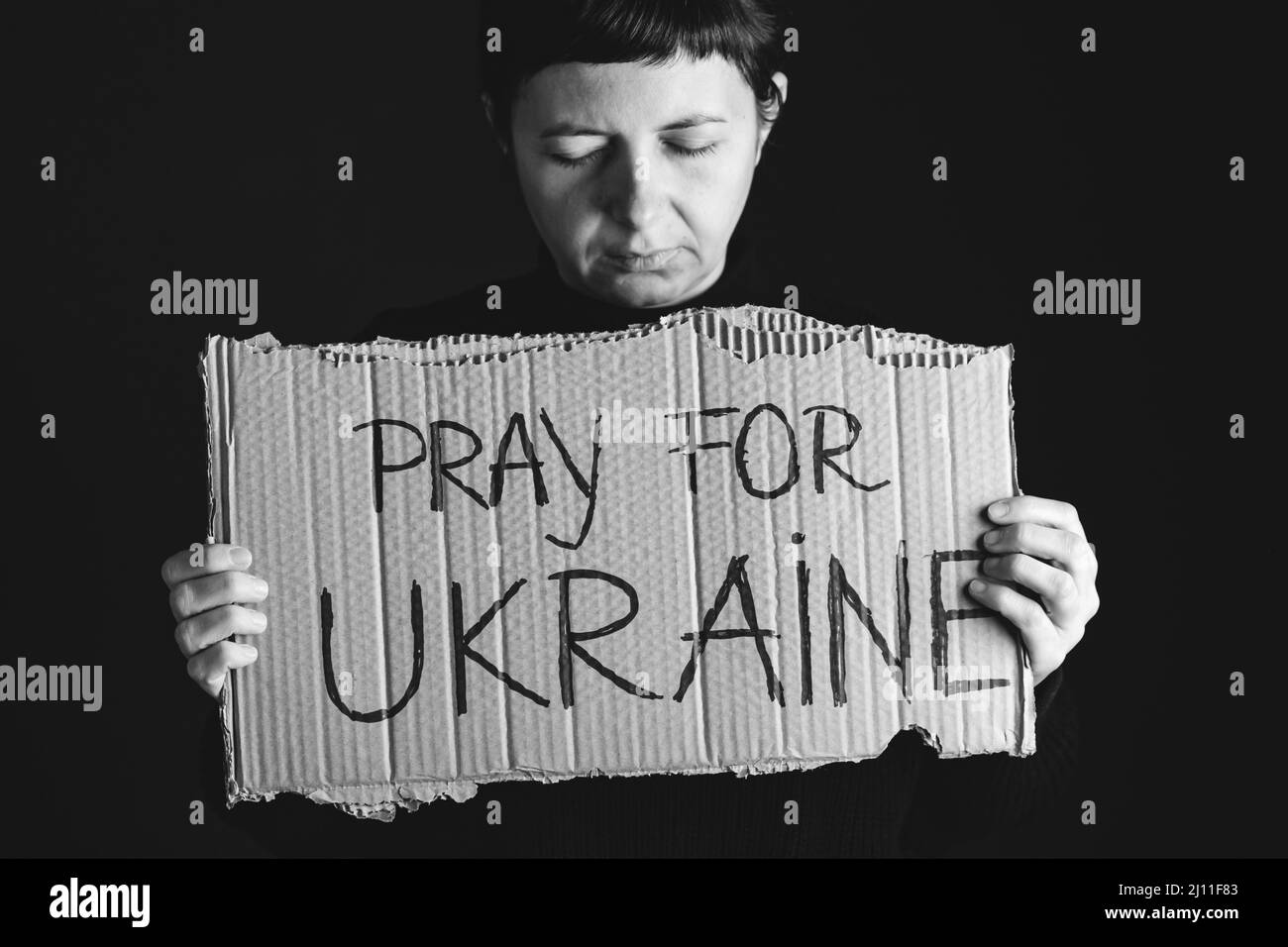 Woman holds a banner with anti-war message. Protest against the Russian ...