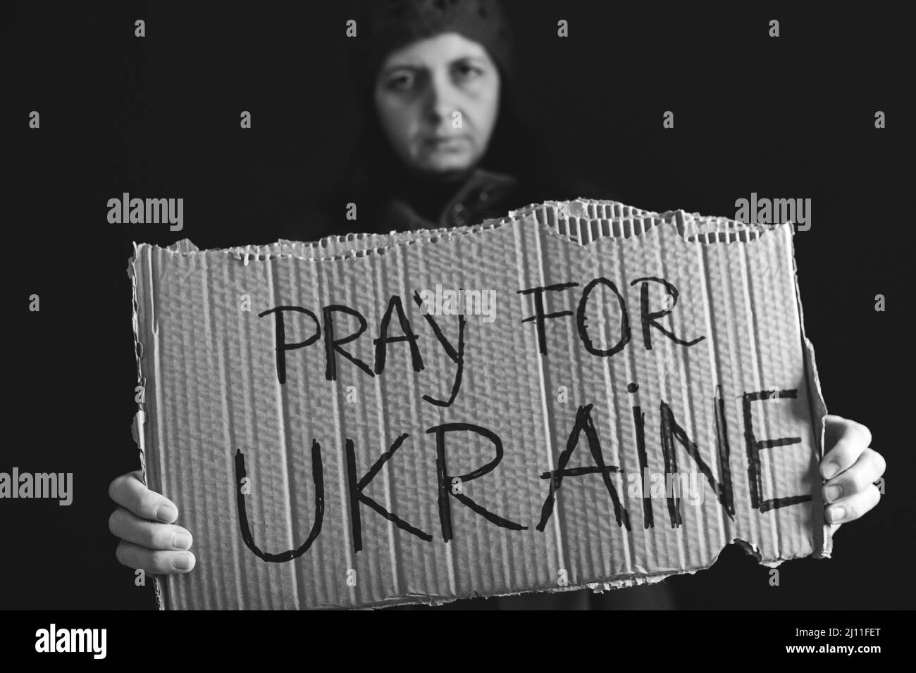 Woman holds a banner with anti-war message. Protest against the Russian ...