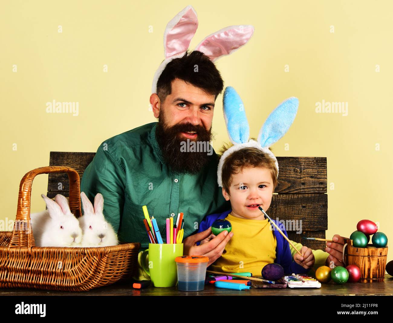 Easter ideas for decorating eggs. Father and son painting Easter egg ...