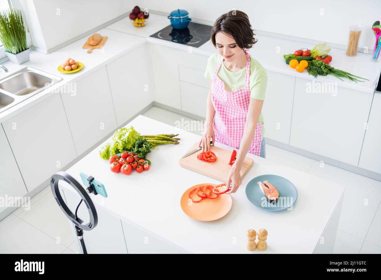 High angle view portrait of beautiful lady vlogger prepare dish paprika ...