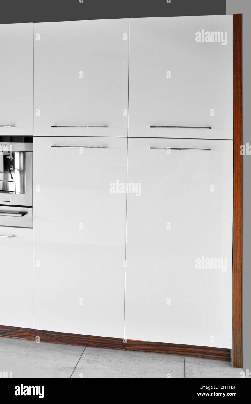 Interior of luxurious modern kitchen equipment, beige lacquer cabinets ...