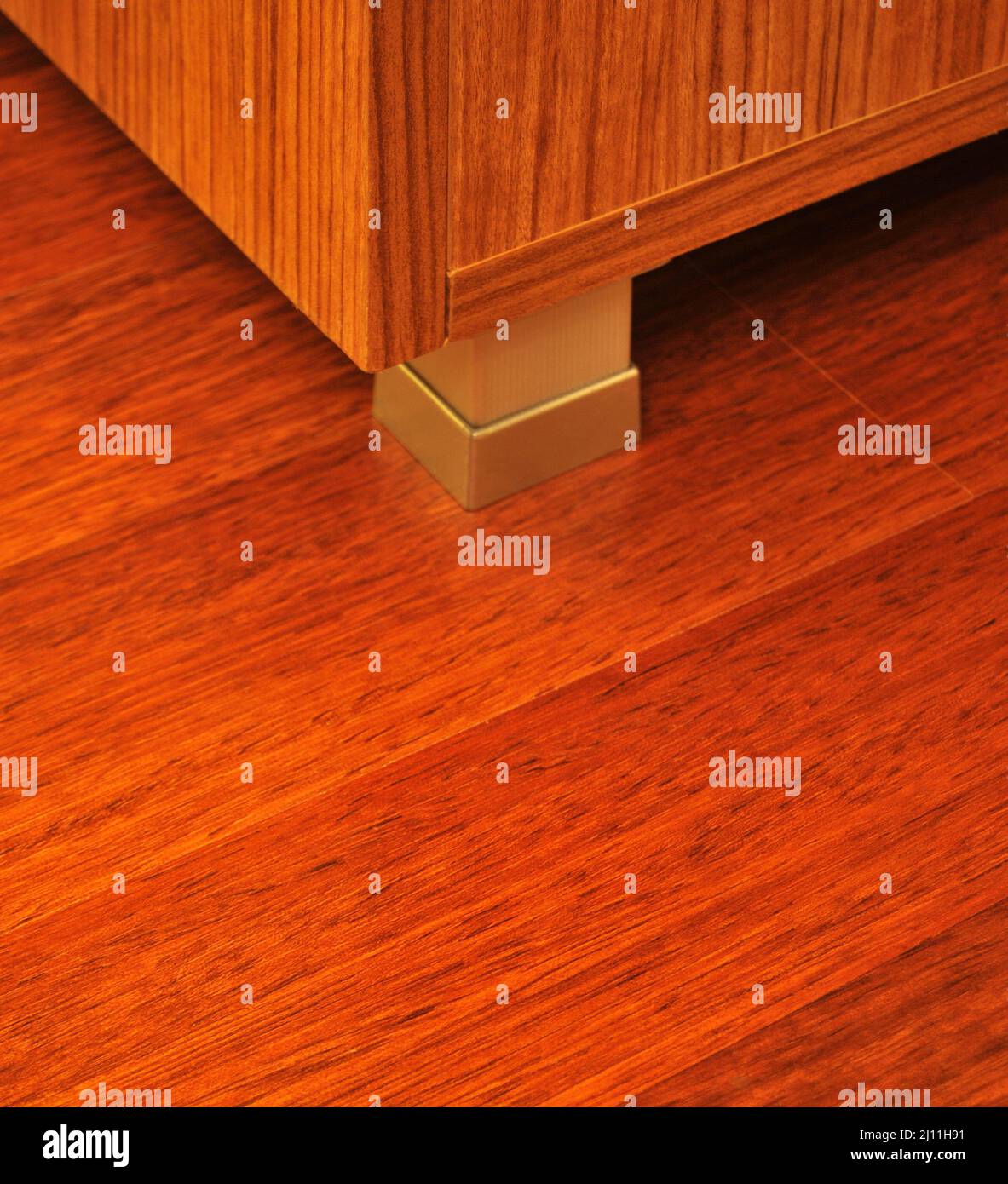 Walnut cabinet and corner detail on mahogany parquet in a luxury house ...