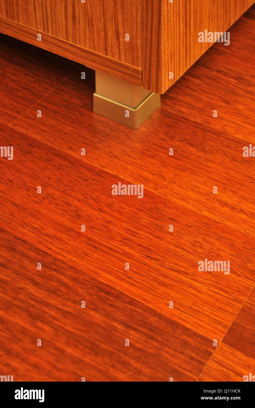 Walnut cabinet and corner detail on mahogany parquet in a luxury house ...