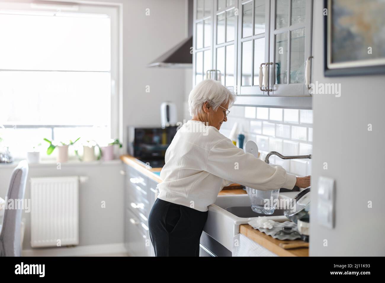 Shot of a senior woman in her kitchen Stock Photo - Alamy