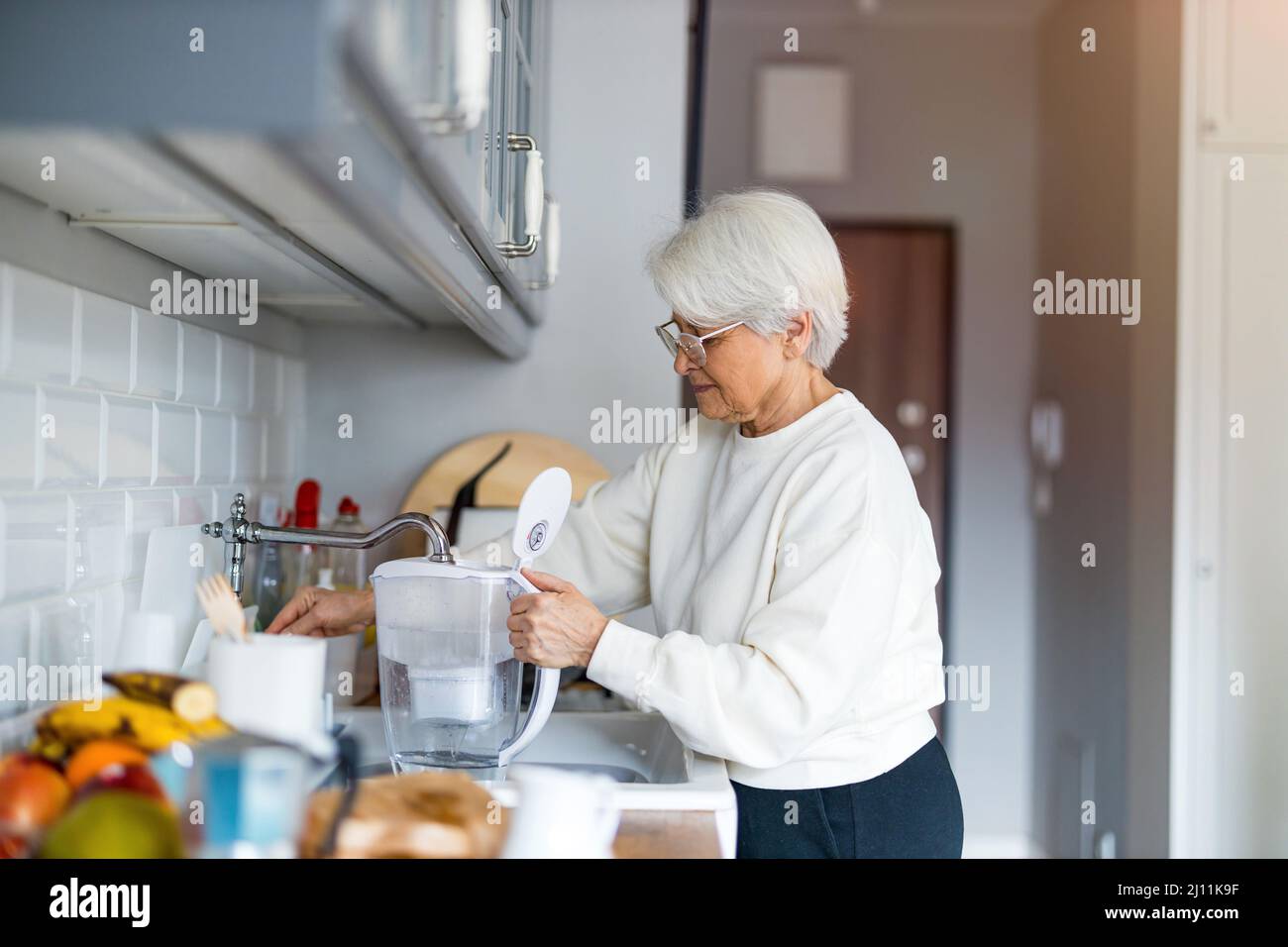 Shot of a senior woman in her kitchen Stock Photo - Alamy