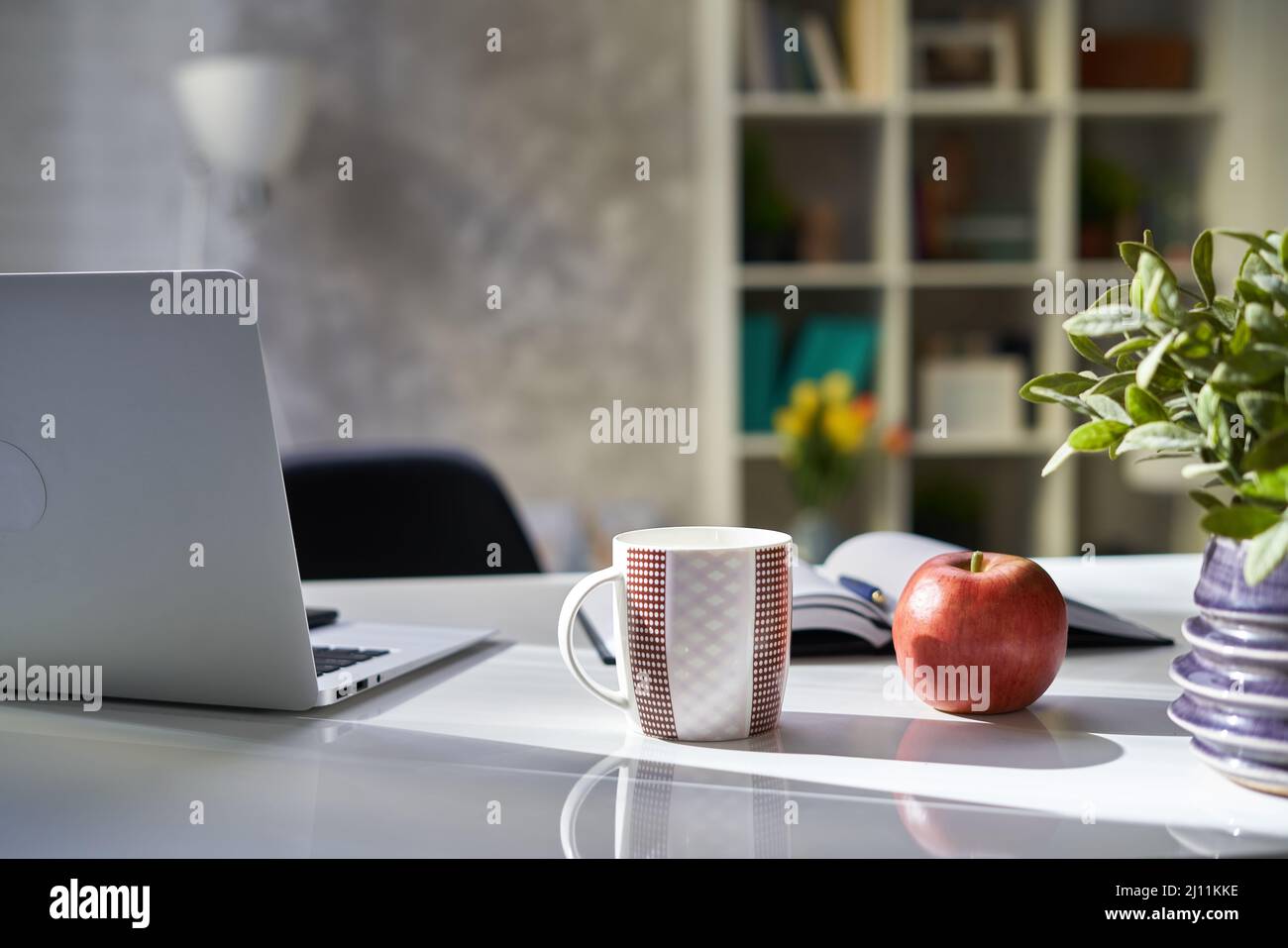 Laptop and cup of coffee or tea on desk at home. Cosy study room in ...